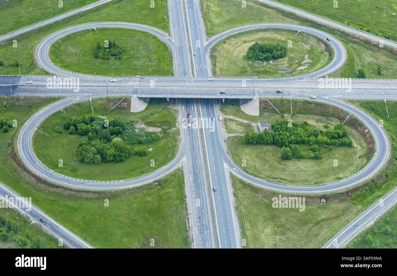 Aerial view of a modern highway intersection with winding roads and a ...