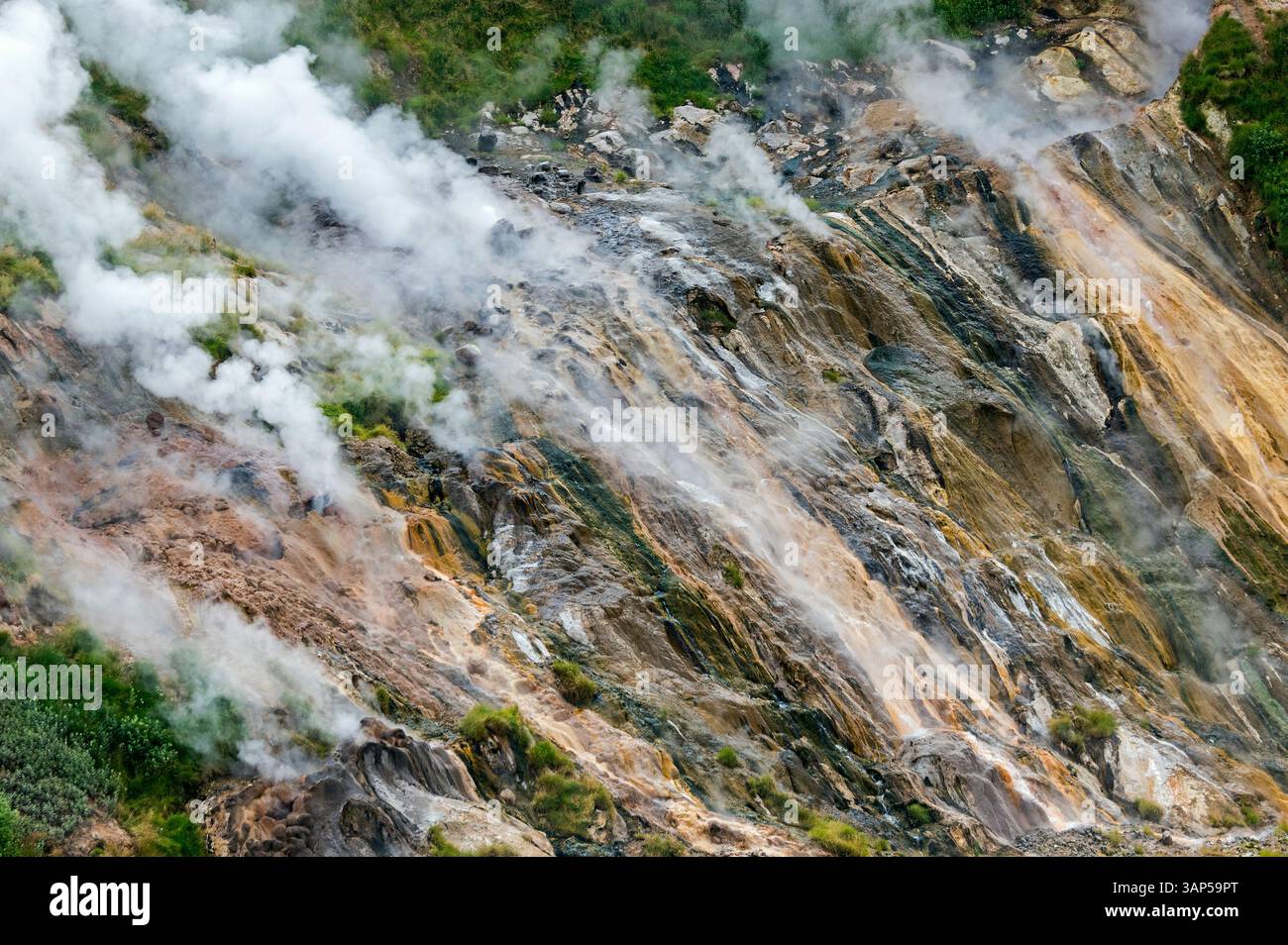 Aerial view of geothermal landscape with steam and rugged rocks ...