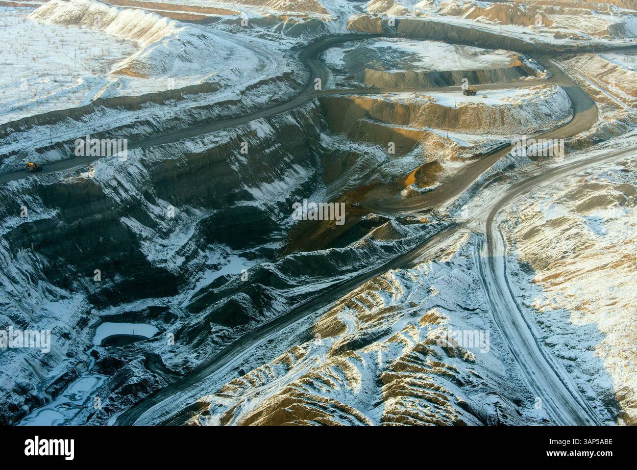 Aerial view of chernogorsky coal mine in winter with snow-covered ...