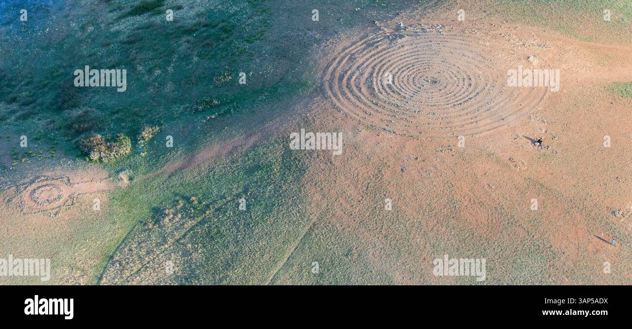 Aerial view of circular patterns in green grass fields at the ...