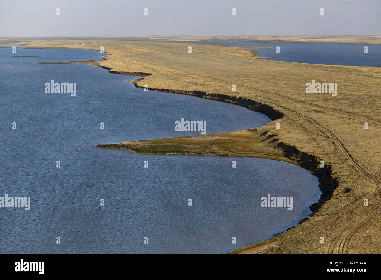 Aerial view of serene wetland landscape with expansive lake and river ...
