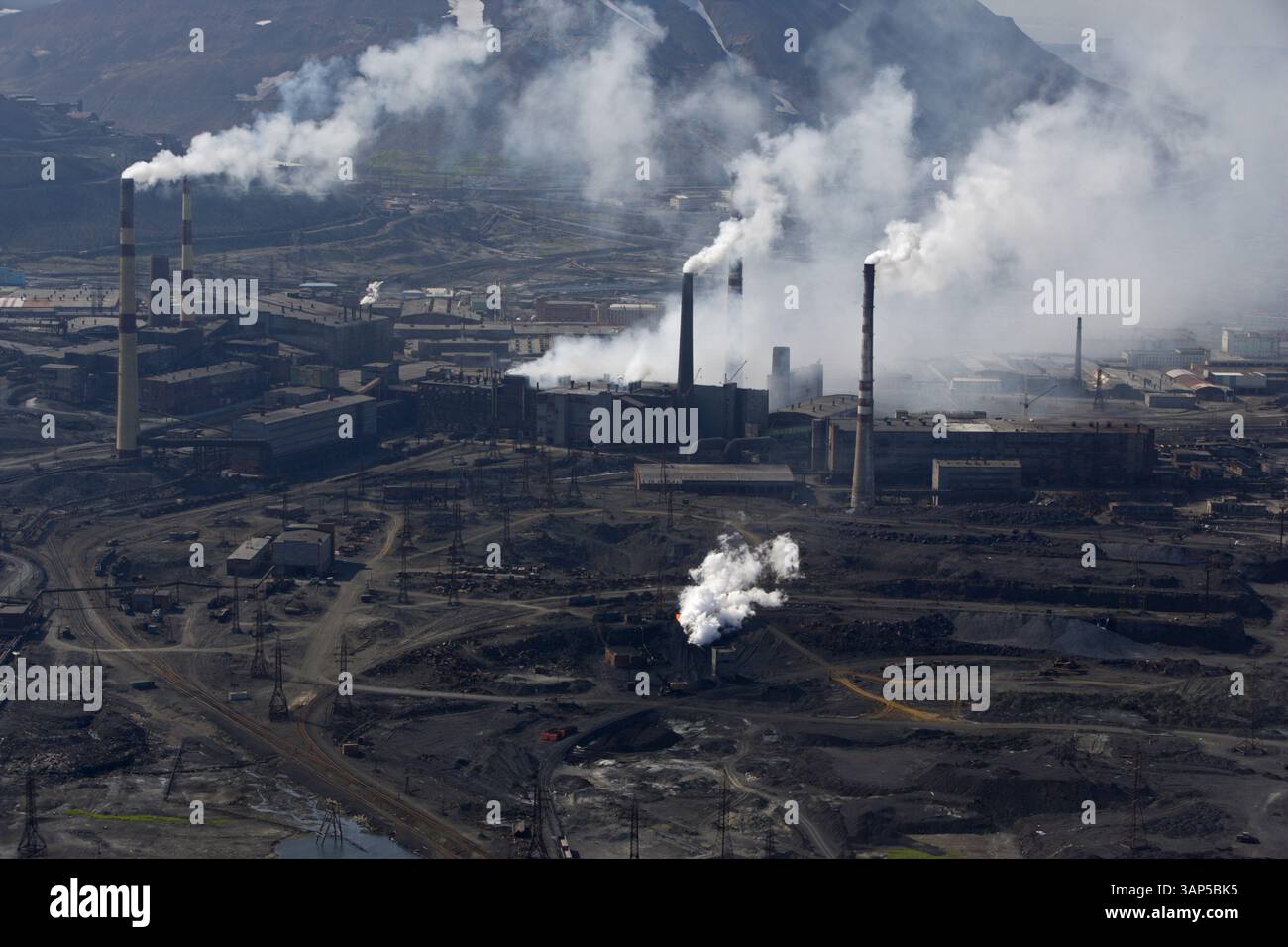 Aerial view of industrial factory with smoke and chimneys in urban ...