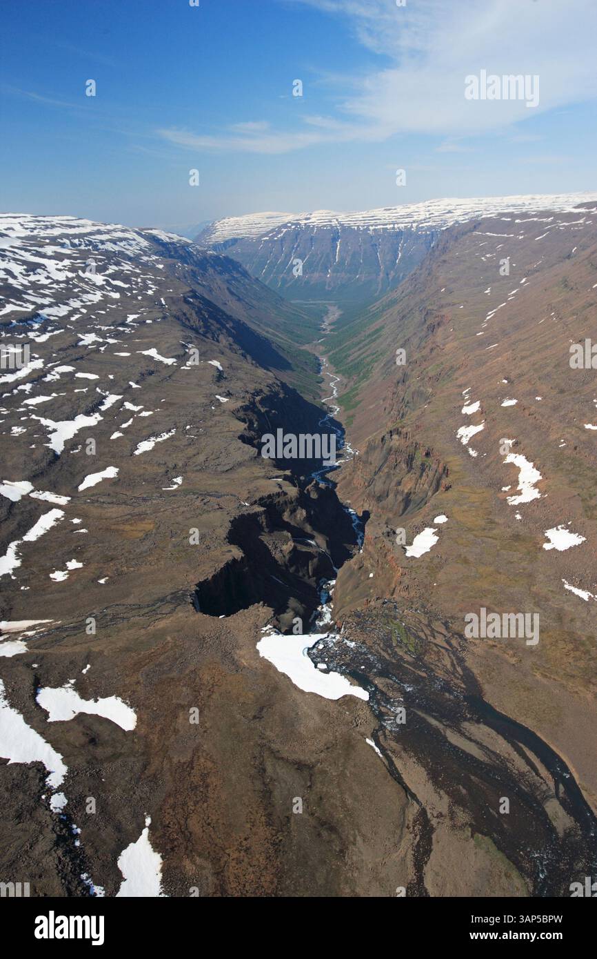 Aerial view of the beautiful Putorana Plateau with snowy mountains and ...