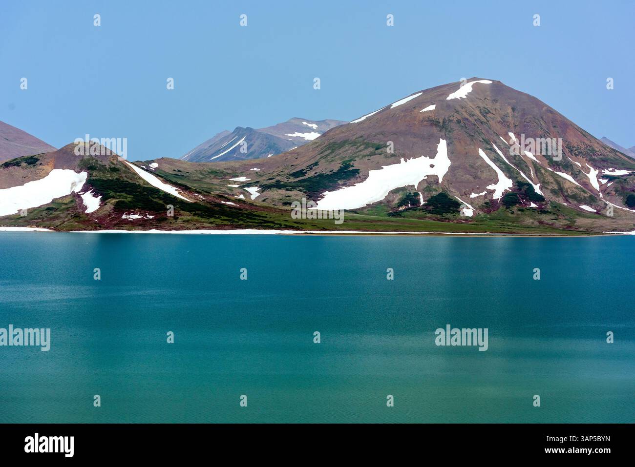 Aerial view of tranquil lake surrounded by majestic mountains and ...
