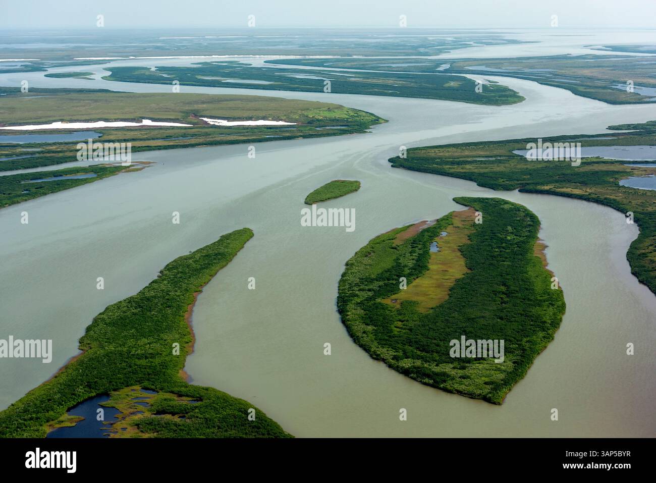 Aerial view of winding river meandering through lush greenery and ...