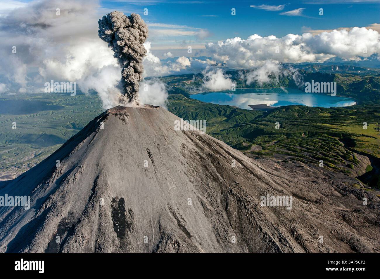 Aerial view of karymsky volcano with smoke plume and crater in a ...