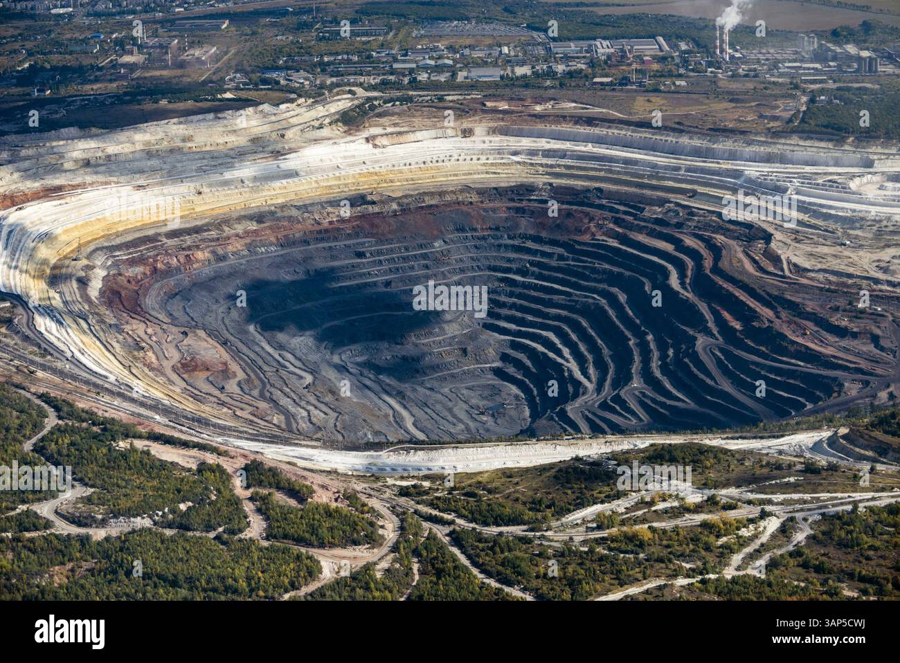 Aerial view of open pit mine with industrial excavation patterns and ...