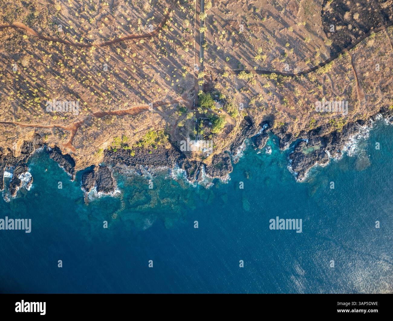 Aerial view of beautiful coastline with rugged cliffs and serene blue ...