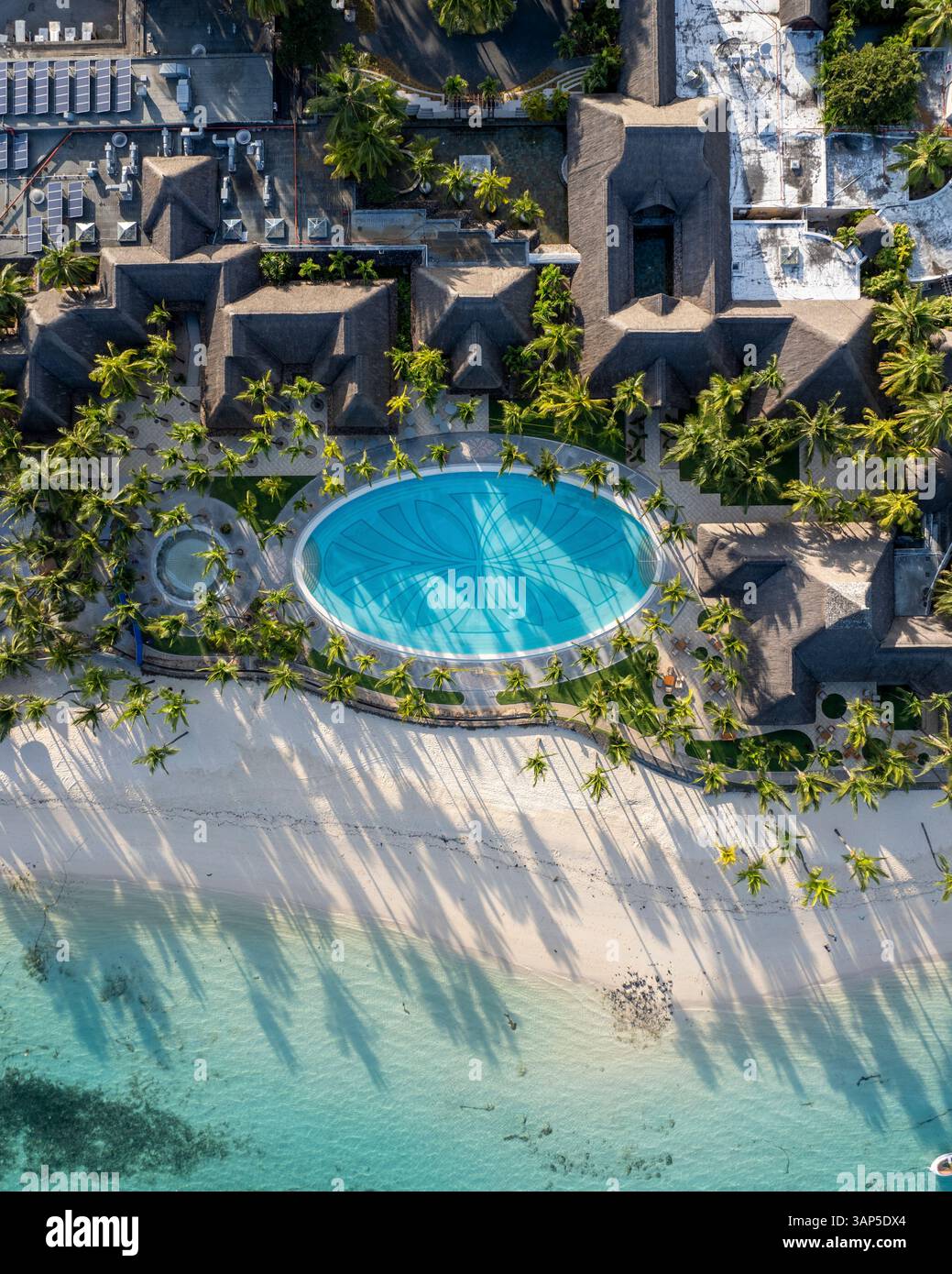 Aerial view of tropical resort with swimming pool and palm trees on ...