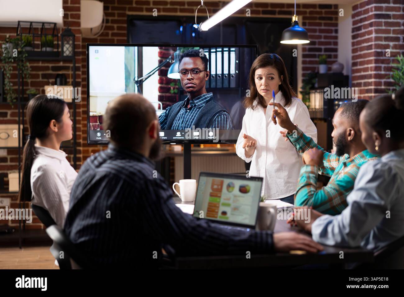 Team collaborates in office analyzing hi-res stock photography and ...