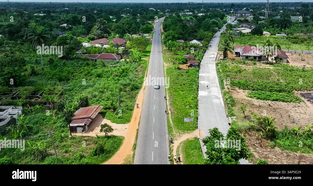 Aerial view of lush greenery along Ahoada Main Road with rural homes ...