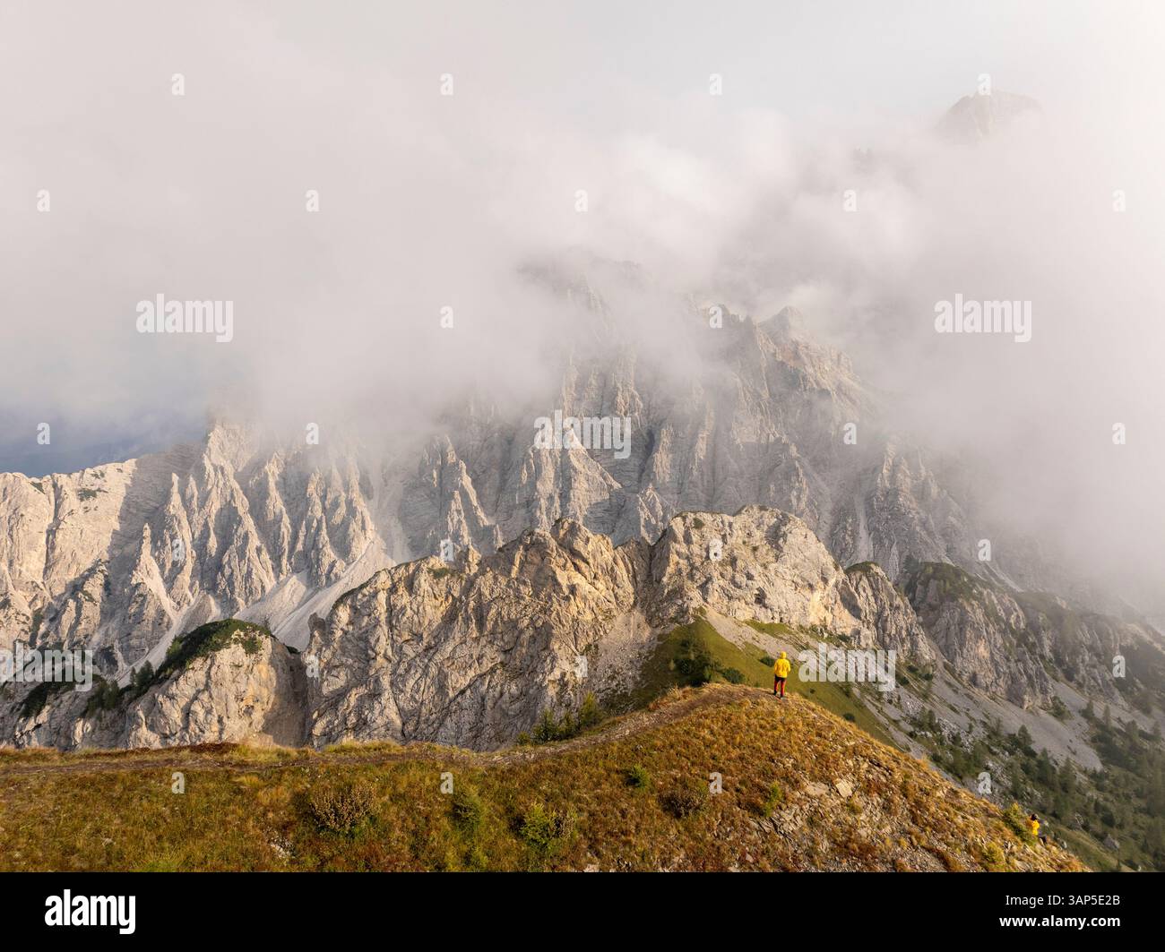 Aerial view of majestic dolomites with rugged peaks and clouds, Borca ...