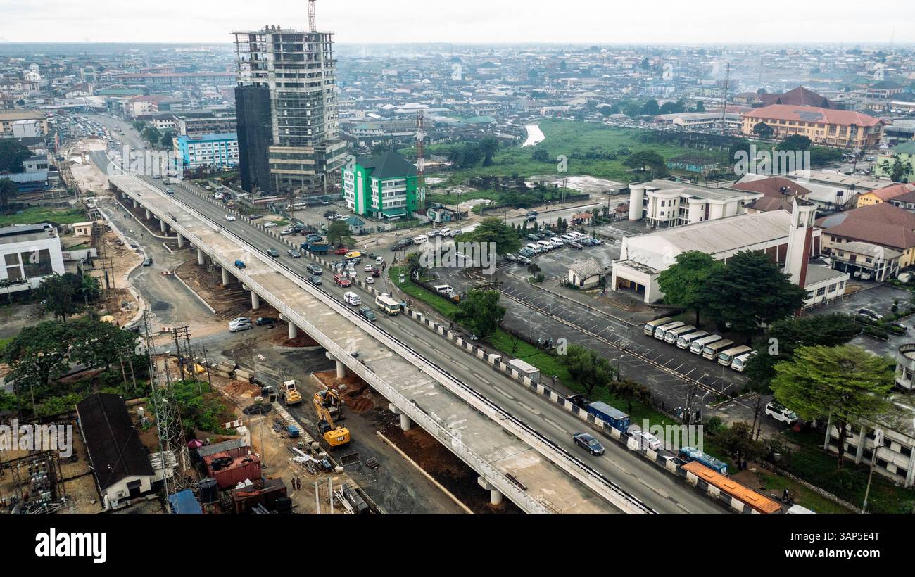Aerial view of overpass construction with busy roads and modern buildings, Port Harcourt ...