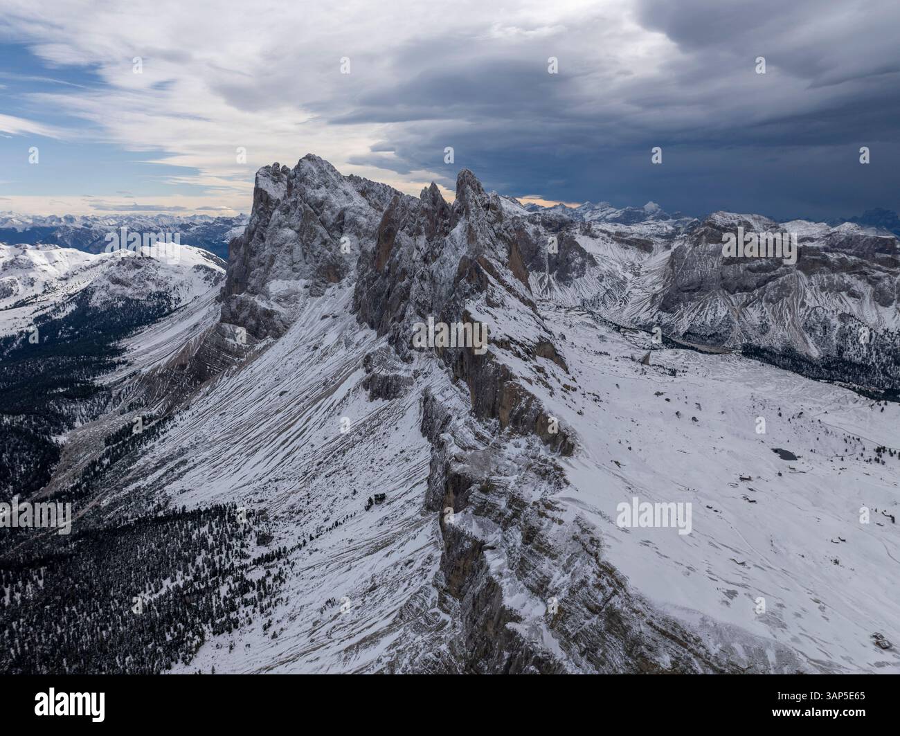 Aerial view of majestic snowy mountains and dramatic sky over the ...