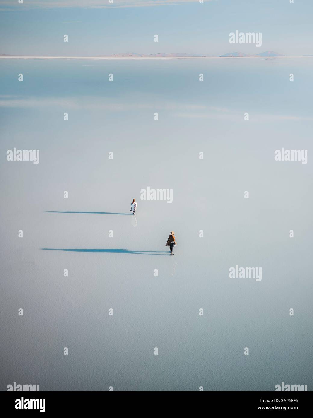 Aerial drone view of people at salt flats in Uyuni salt lake, Bolivia ...