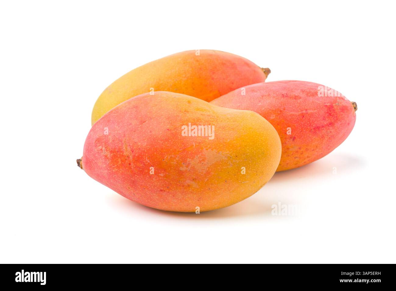 Ripe mangoes on white Cut Out Stock Images & Pictures - Alamy