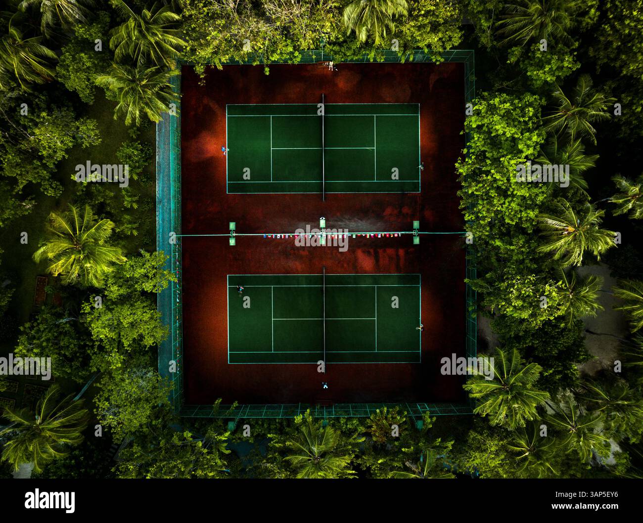 Aerial view of Tennis courts in a luxury resort on the Himmafushi Atoll ...
