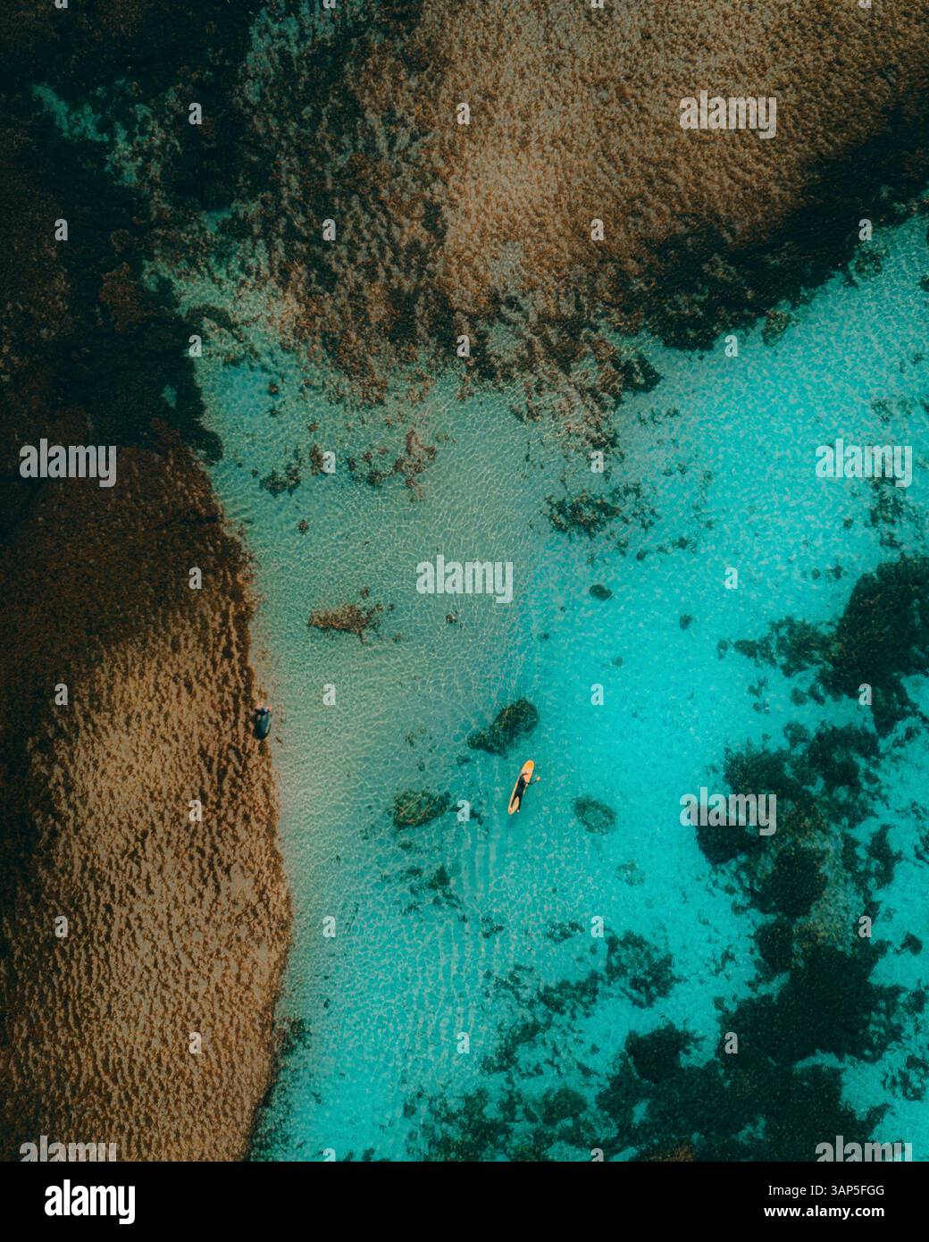 Aerial view of people swimming and snorkelling along Pink Beach on ...