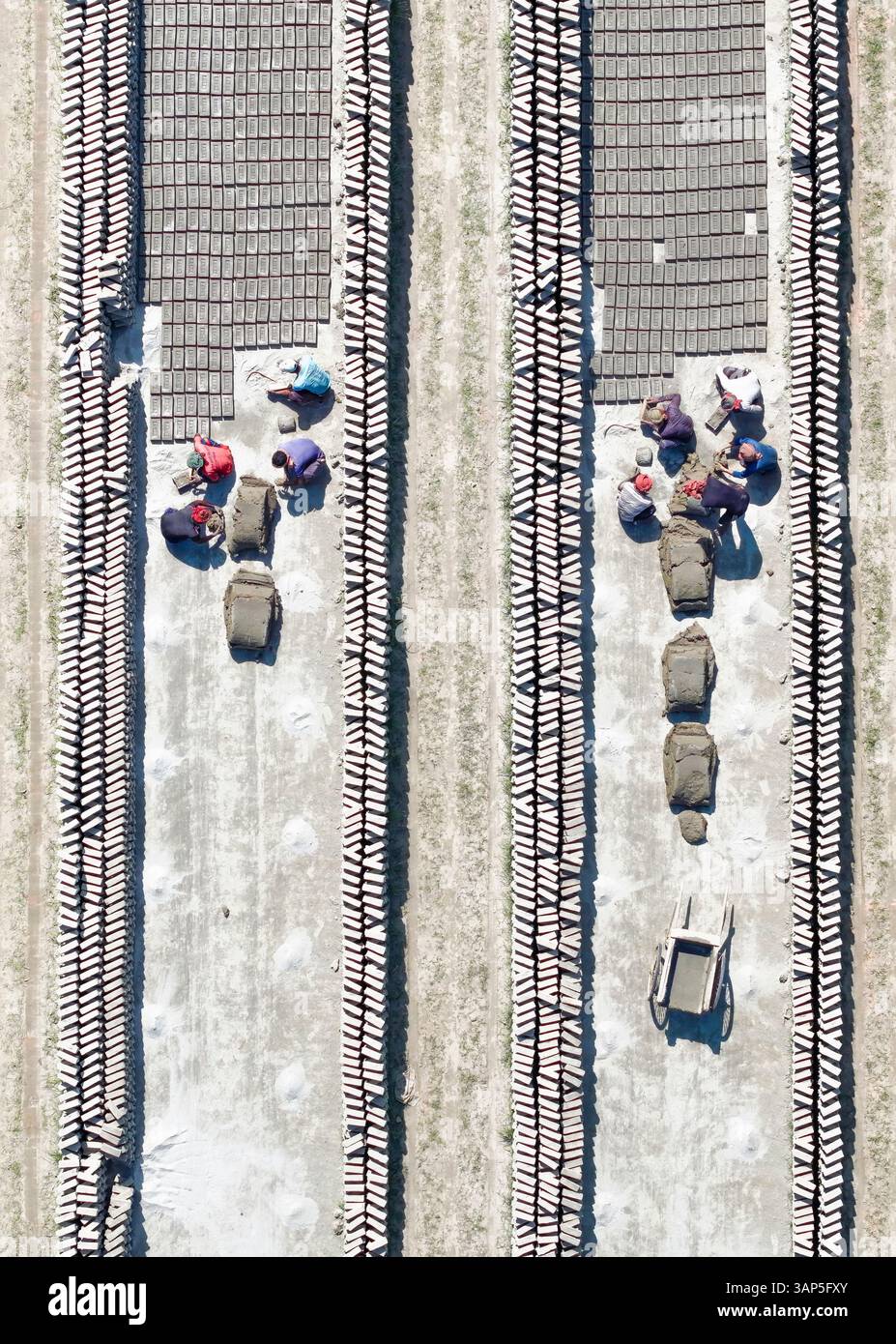Aerial view of a bustling brick factory with workers and intricate ...