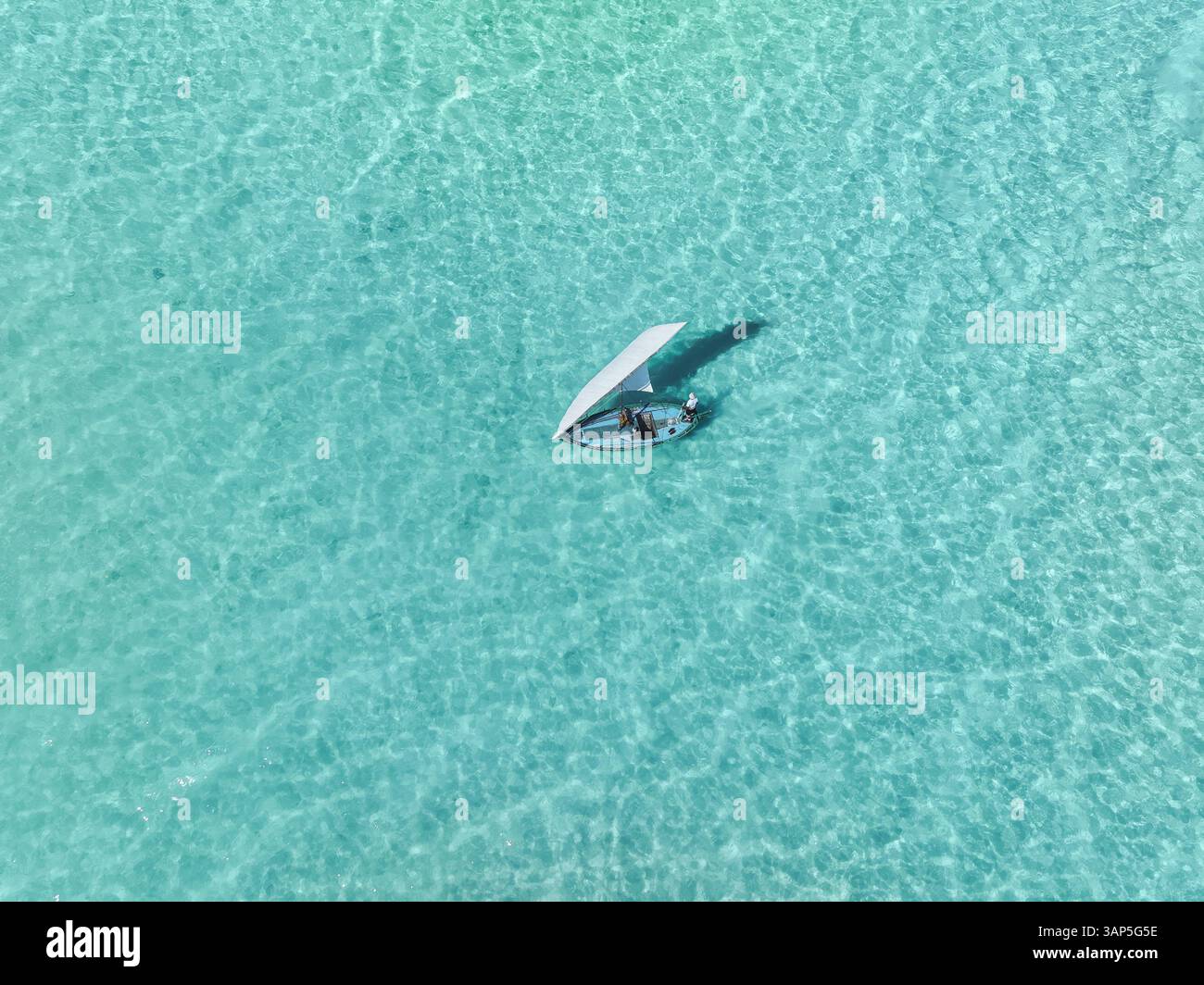 Aerial view of a traditional Maldivian dhoni sailing on turquoise water ...