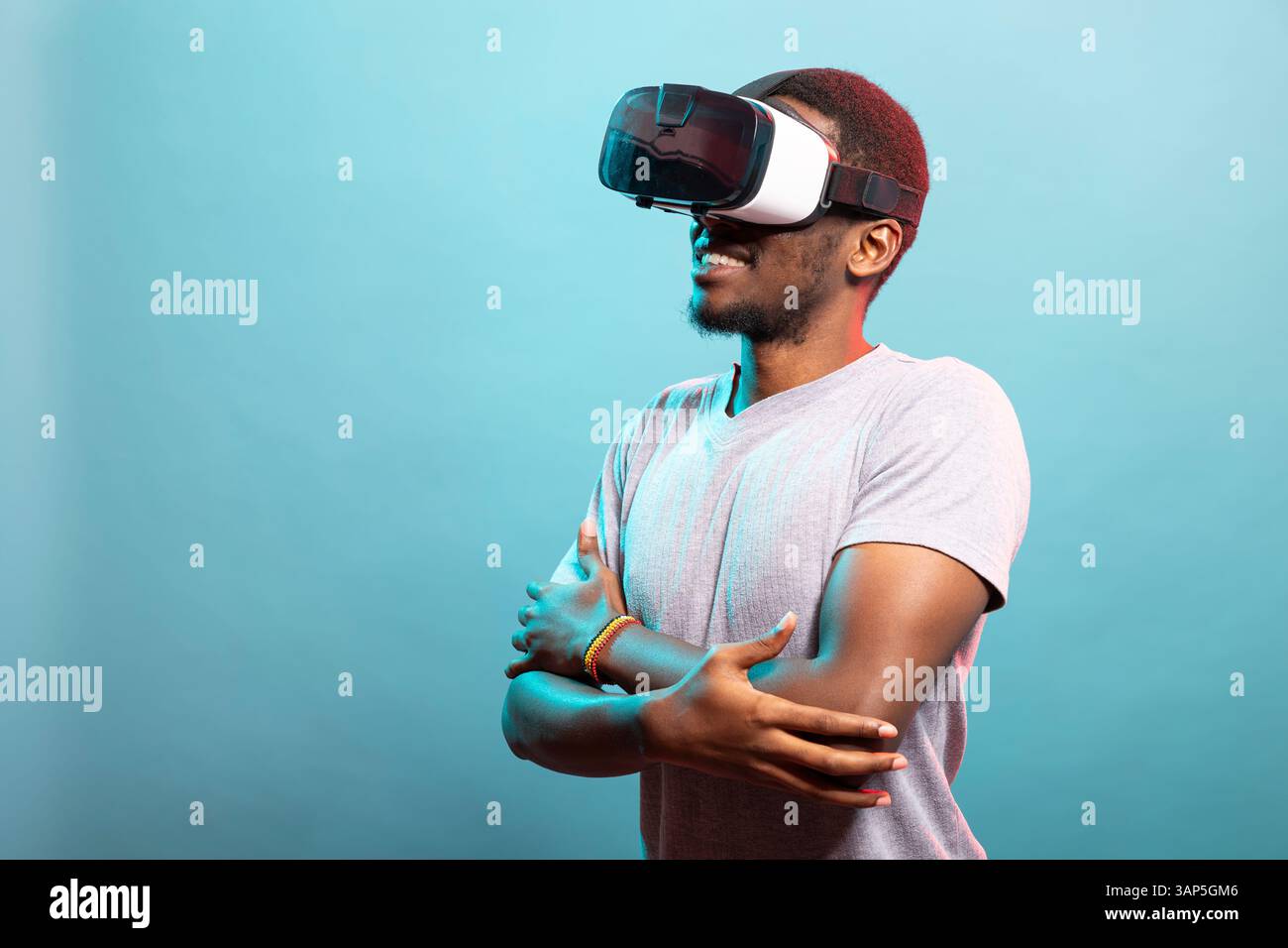 Young male individual enjoying an immersive VR experience, interacting ...