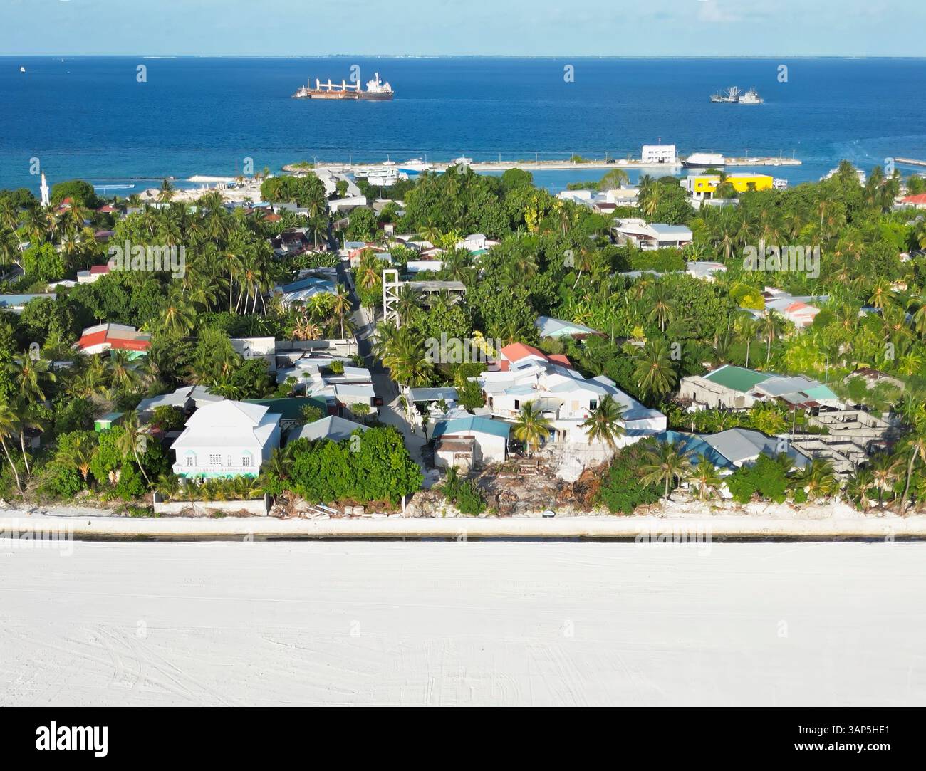 Aerial view of artificial island with palm trees and houses, Maradhoo ...