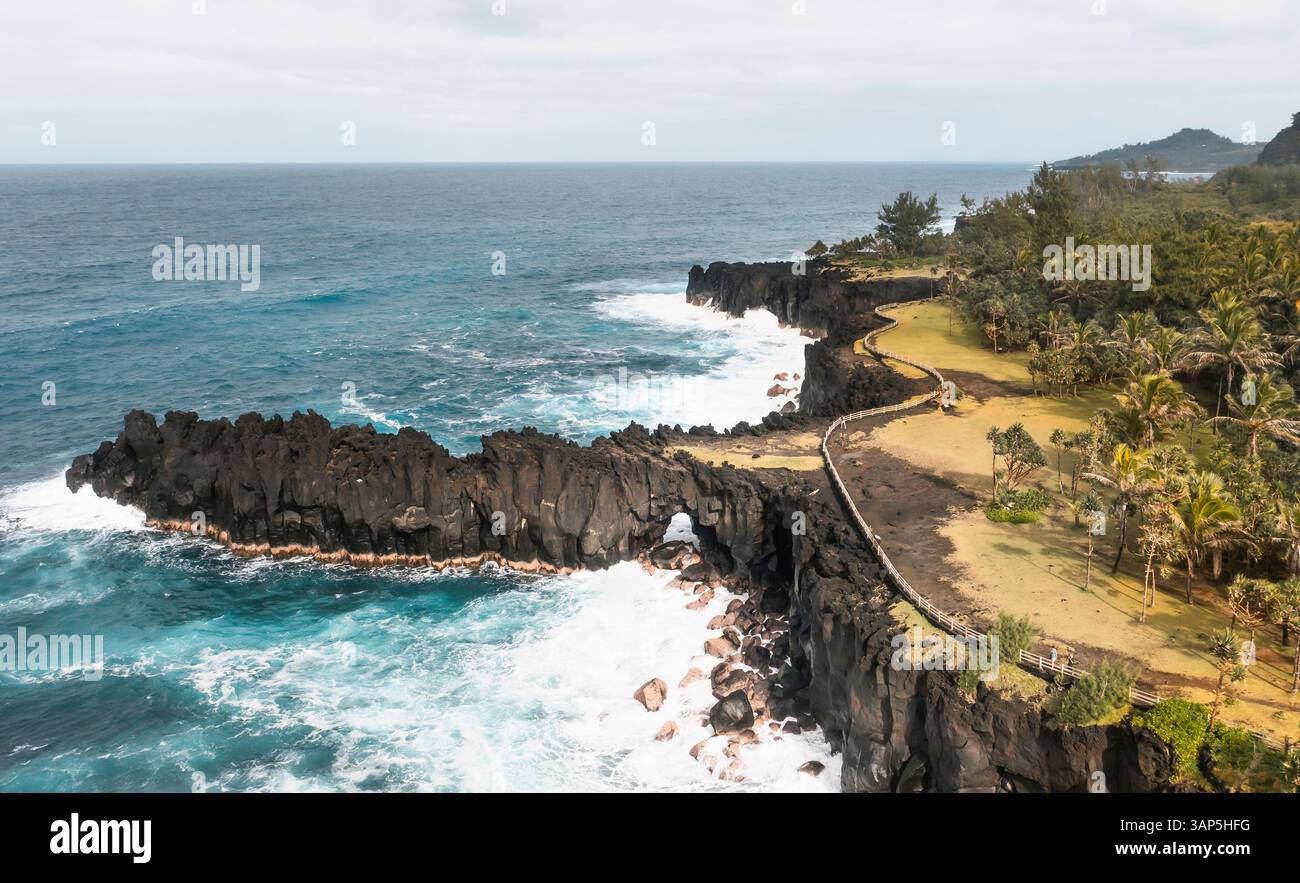 Aerial view of rough and wild cliffs with stormy waves and mist, Puits ...