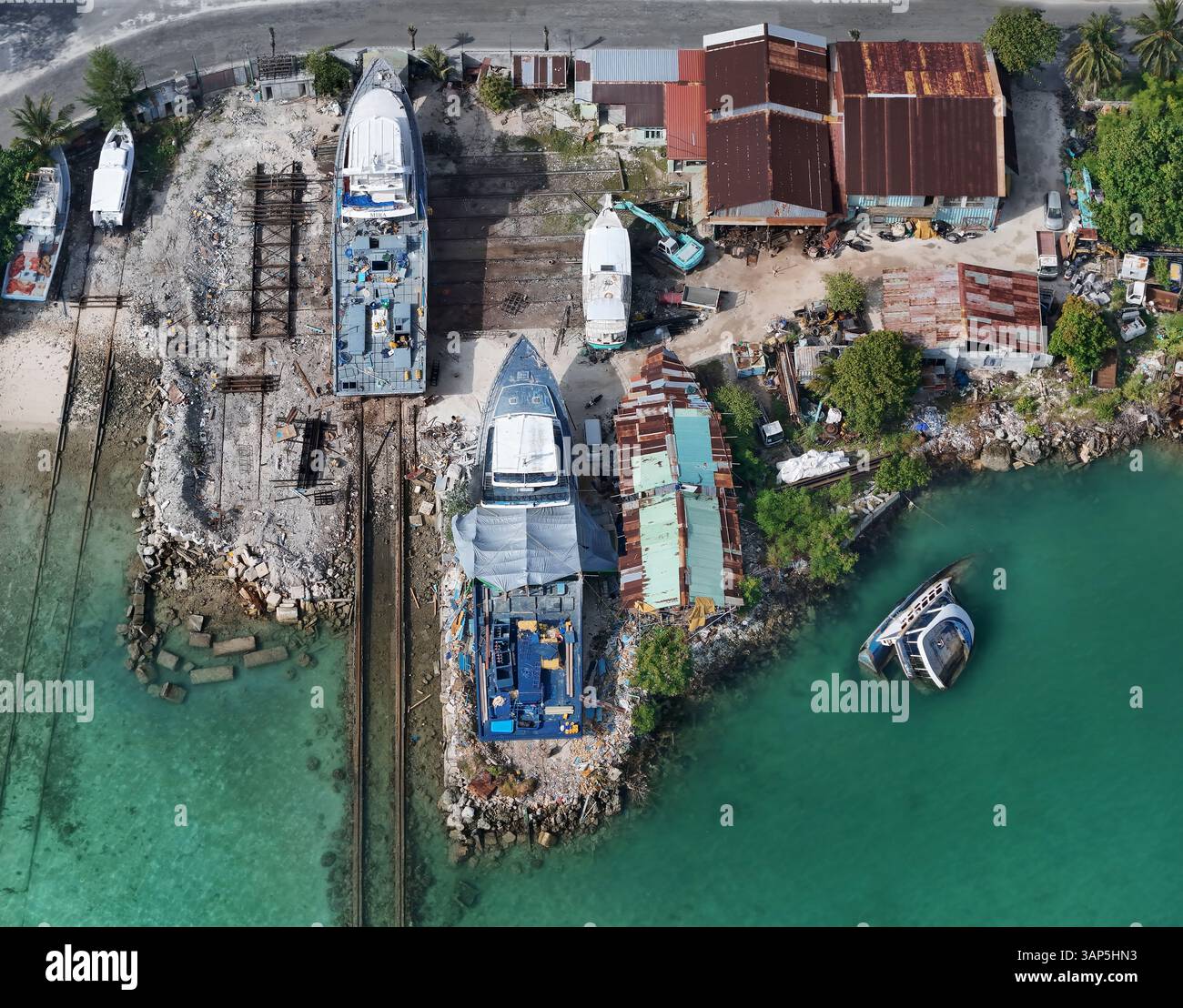Aerial view of beautiful village by the sea with sunken boat and wreck ...