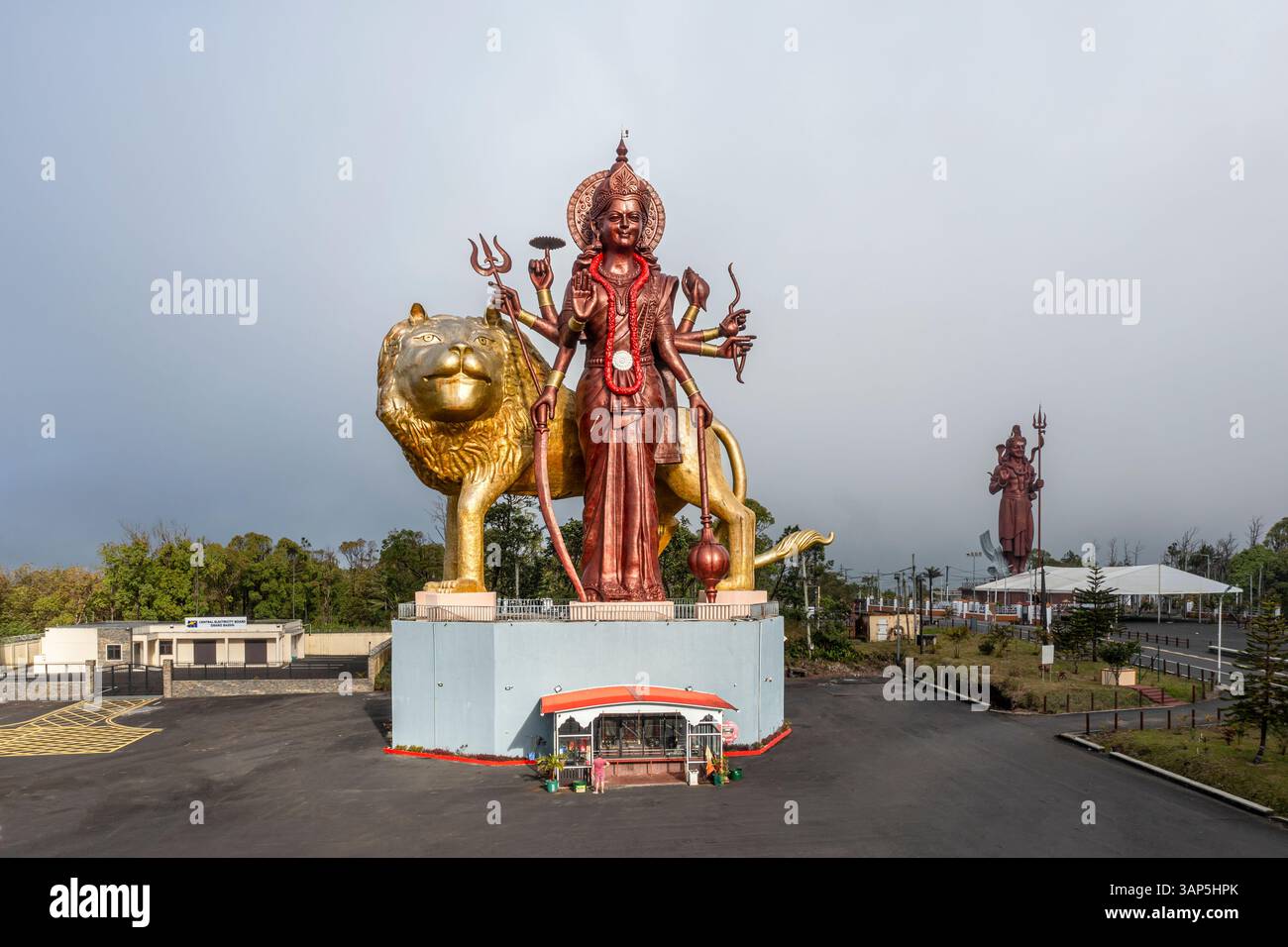 Aerial view of gigantic golden Durga Maa Bhavani statue in misty Grand ...