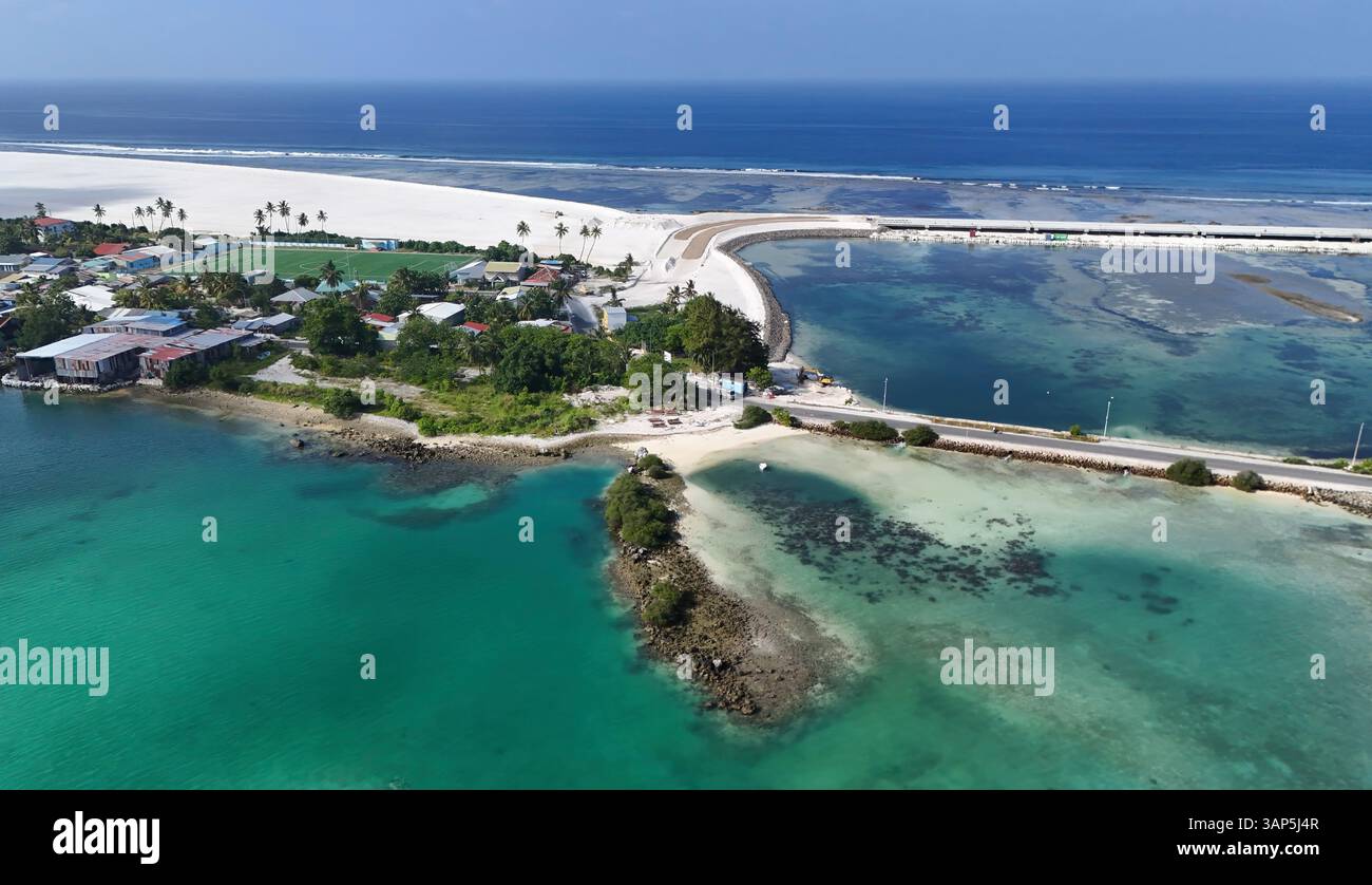 Aerial view of reclamation project with houses, sand, and bridge ...