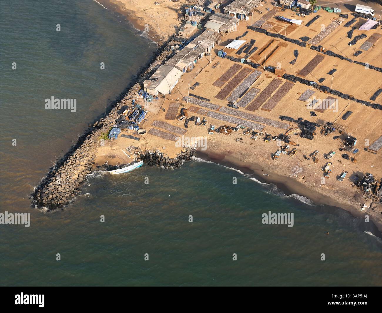 Aerial view of coastal fish market with boats and fishing nets, Negombo ...