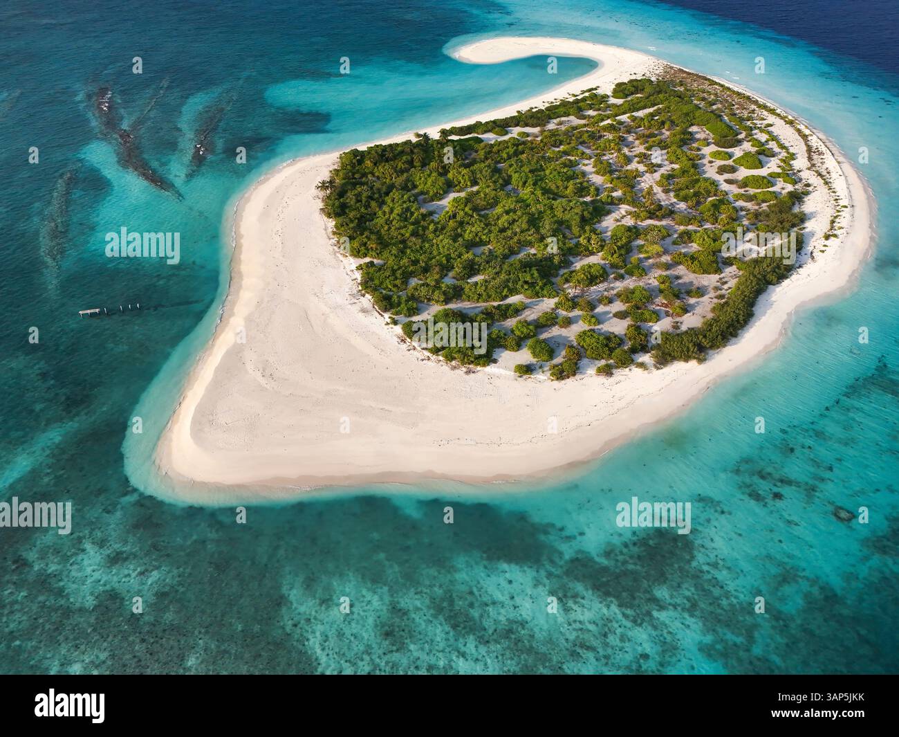 Aerial view of uninhabited island surrounded by turquoise waters in ...