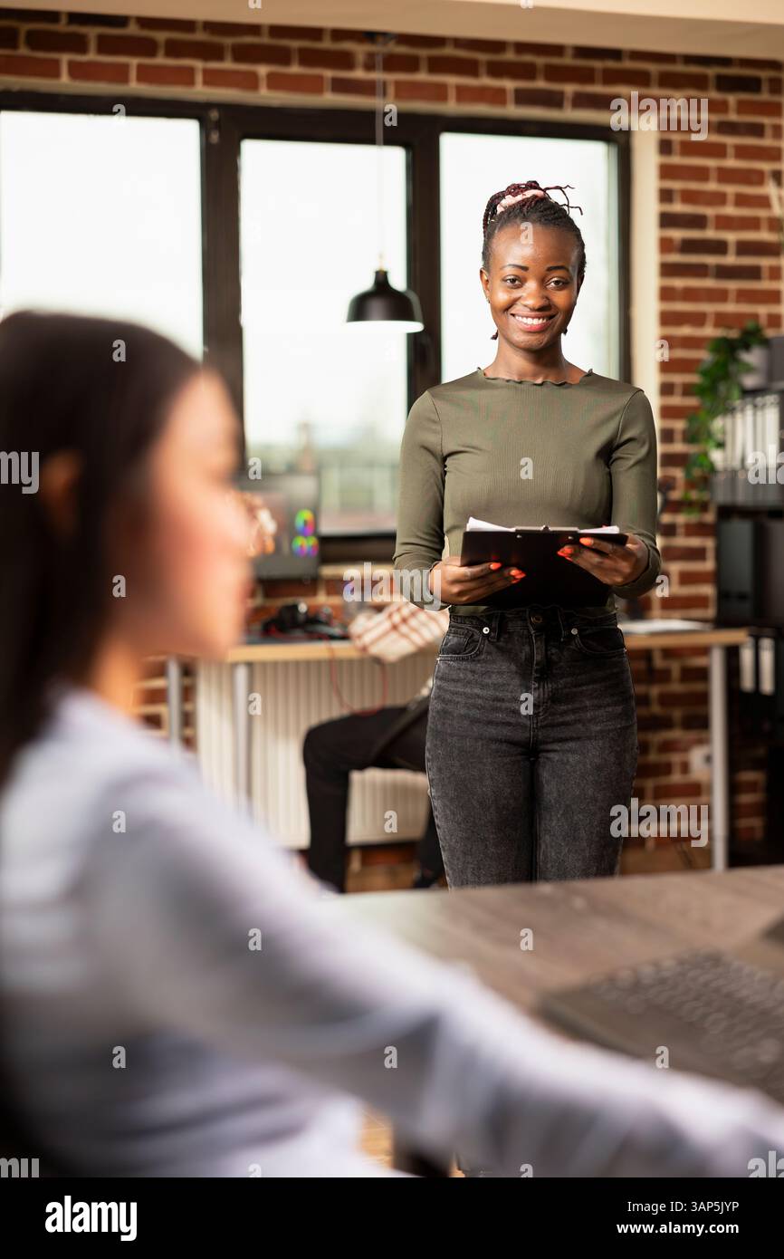 African american woman in workspace, looking excited and prepared for ...