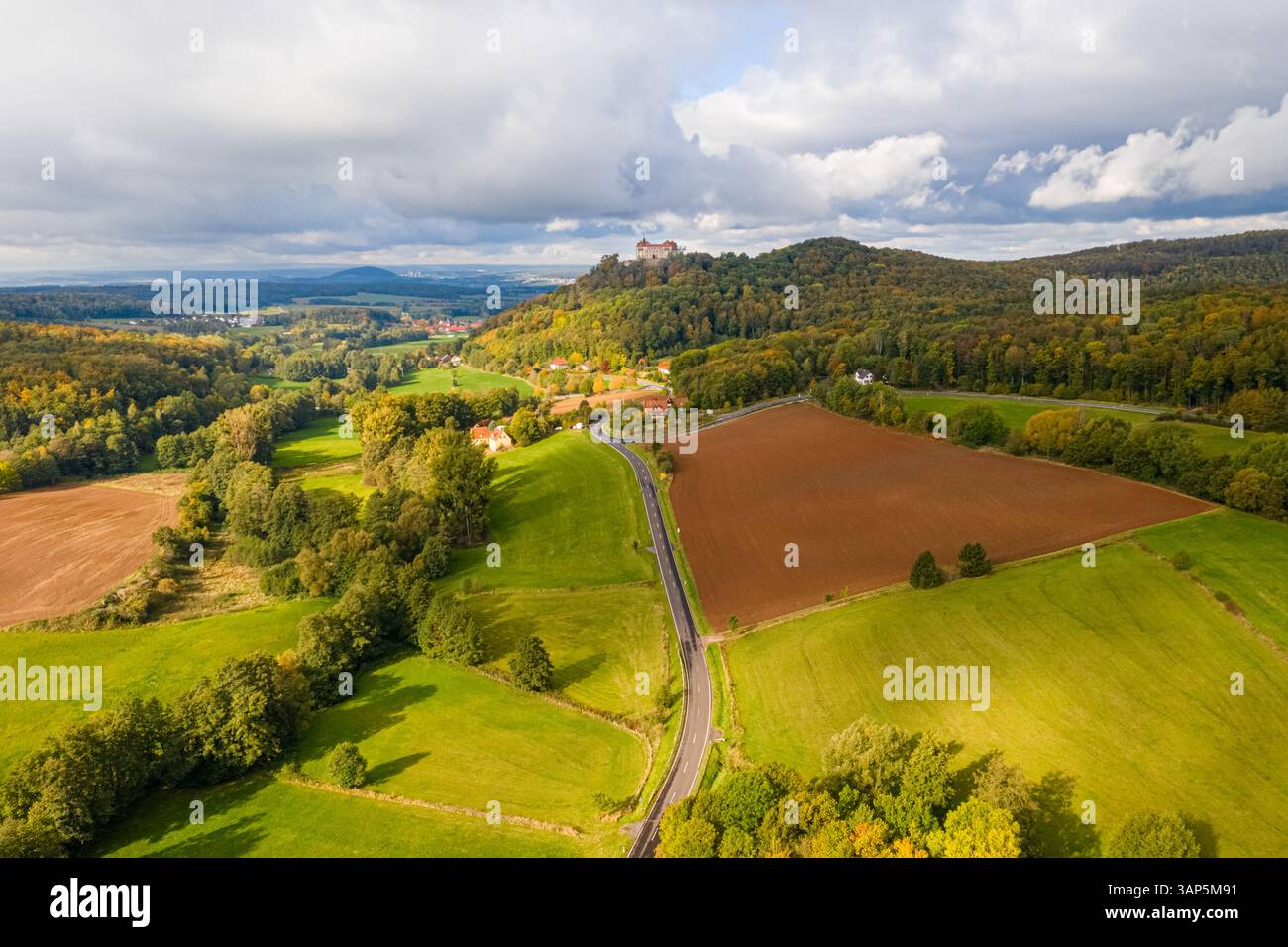Aerial view of a rural landscape with a castle on the hill in autumn ...