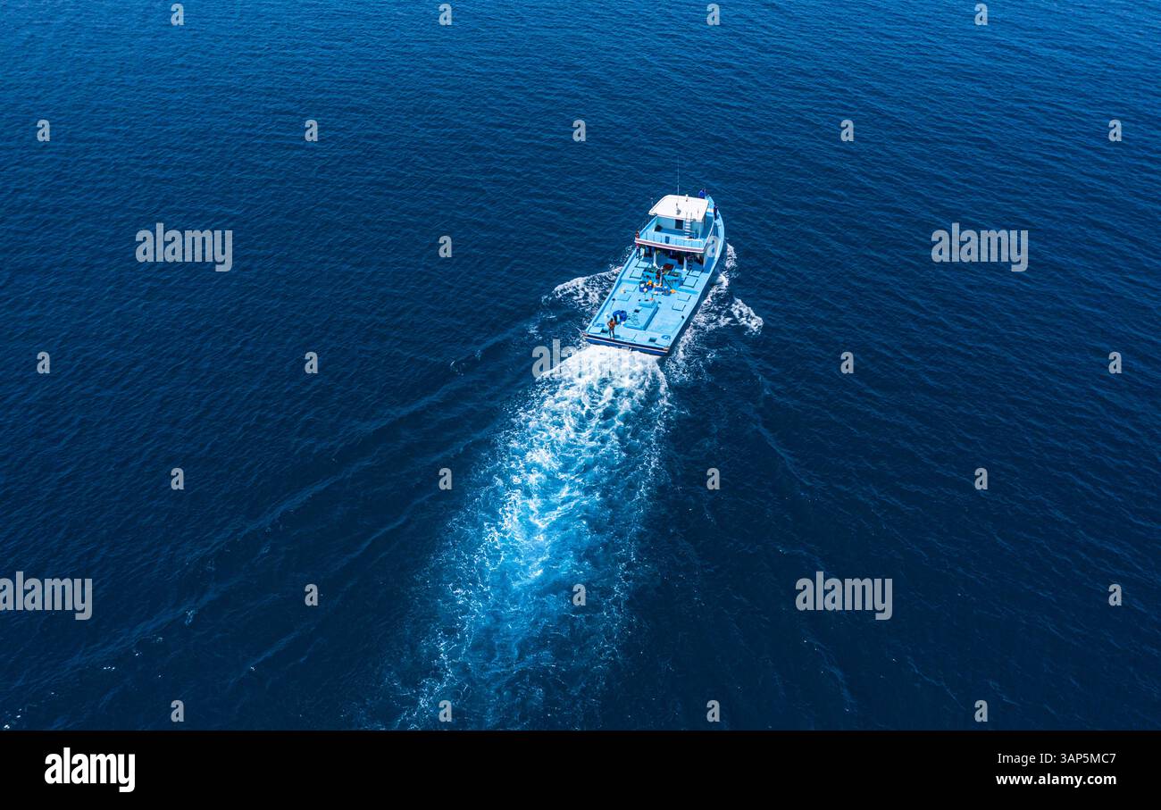Aerial view of a boat / dhoni leaving the harbour of the local ...