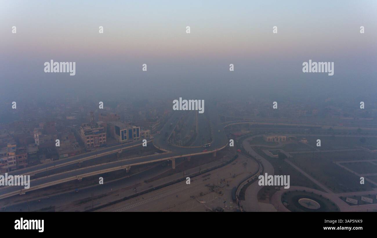 Aerial view of the foggy skyline featuring Minar-e-Pakistan amidst a ...