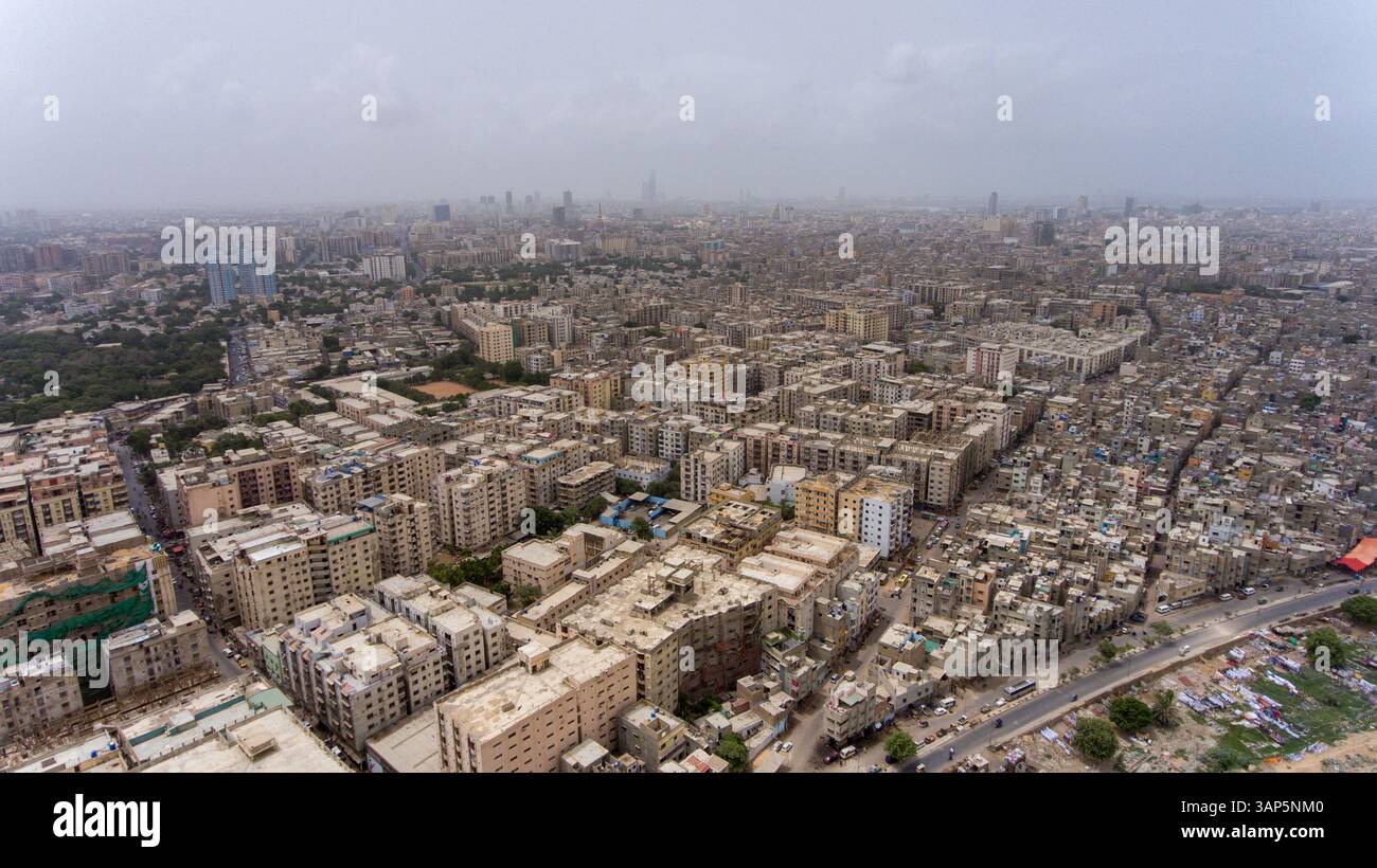 Aerial view of bustling urban cityscape with high-rise buildings and busy roads, Lyari ...