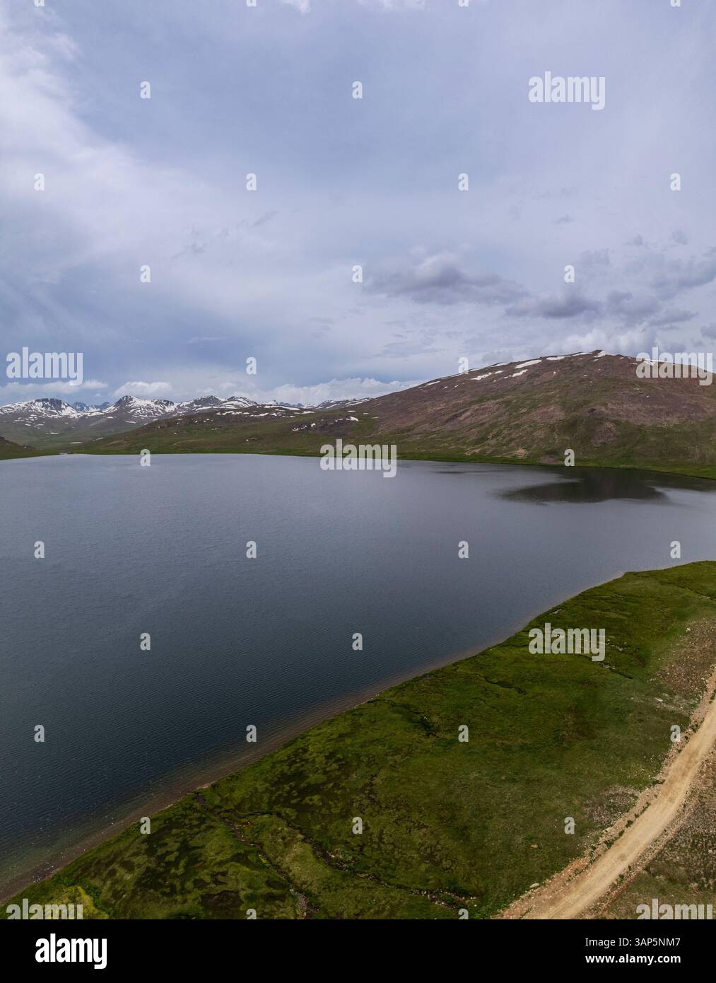 Aerial view of serene Deosai Plains with tranquil lake and majestic ...
