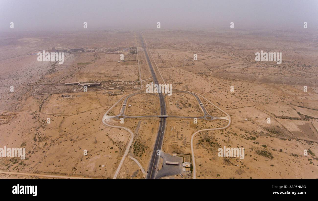 Aerial view of golden sandy desert landscape with Hyderabad Motorway ...