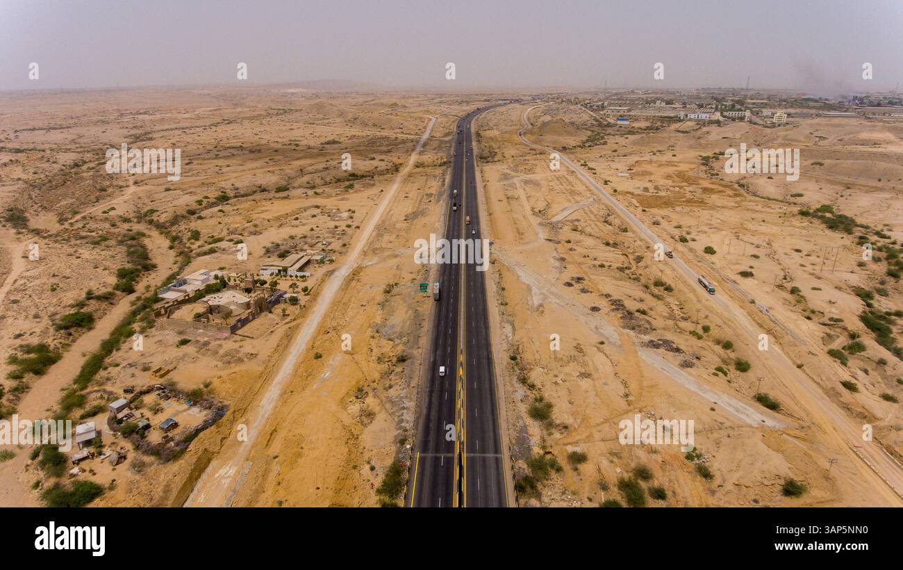 Aerial view of a barren highway stretching through a sandy desert ...