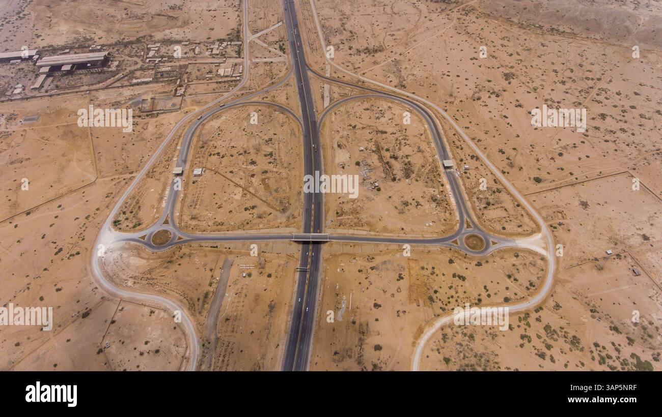 Aerial view of the hyderabad motorway crossing through a barren desert ...