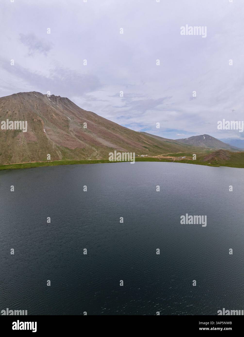 Aerial view of serene Deosai Plains with majestic mountains and a ...