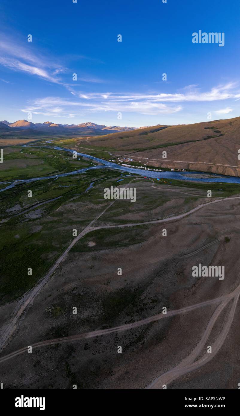 Aerial view of deosai plains with majestic mountains, serene river, and ...