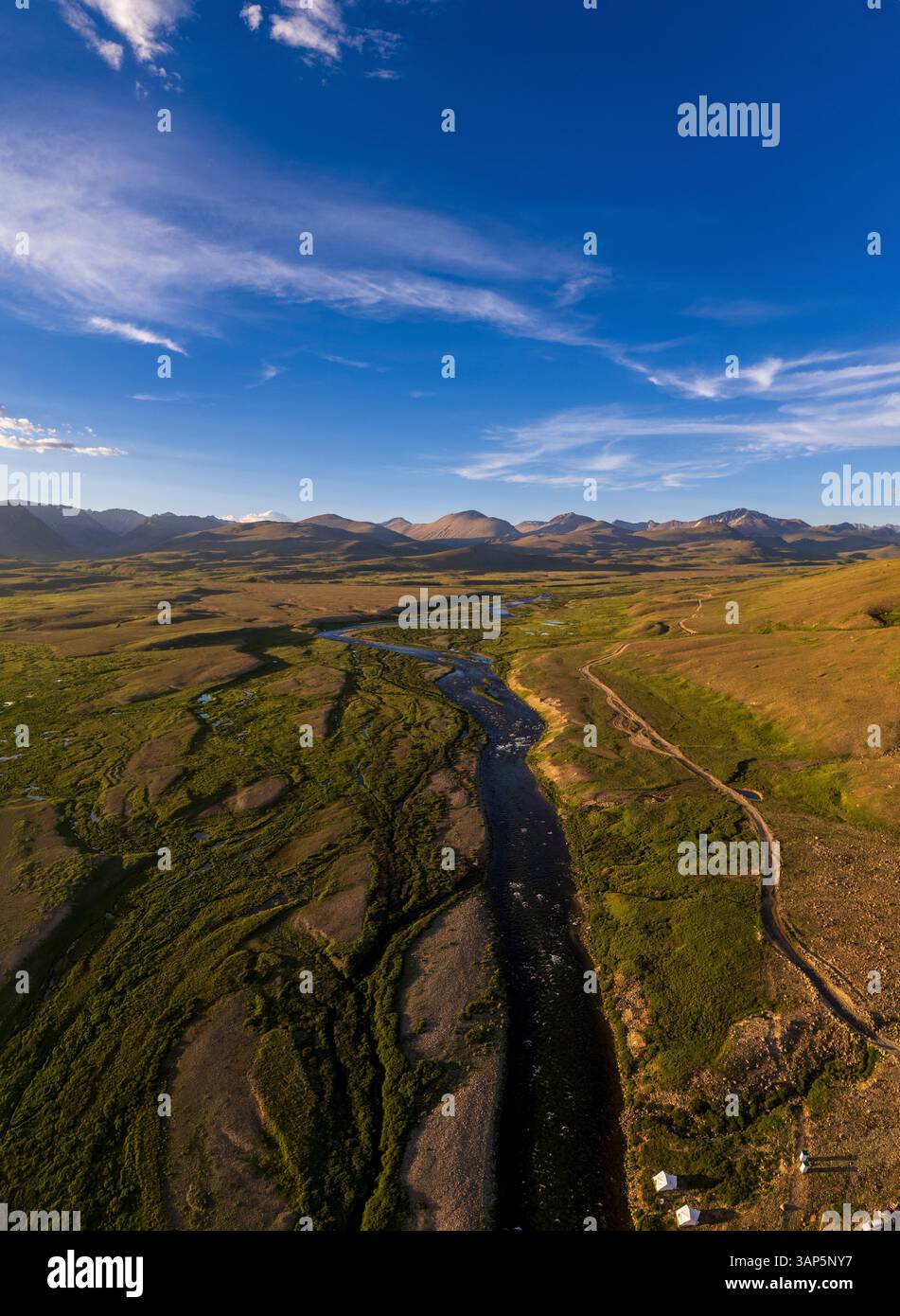 Aerial view of deosai plains with majestic mountains and a serene river ...