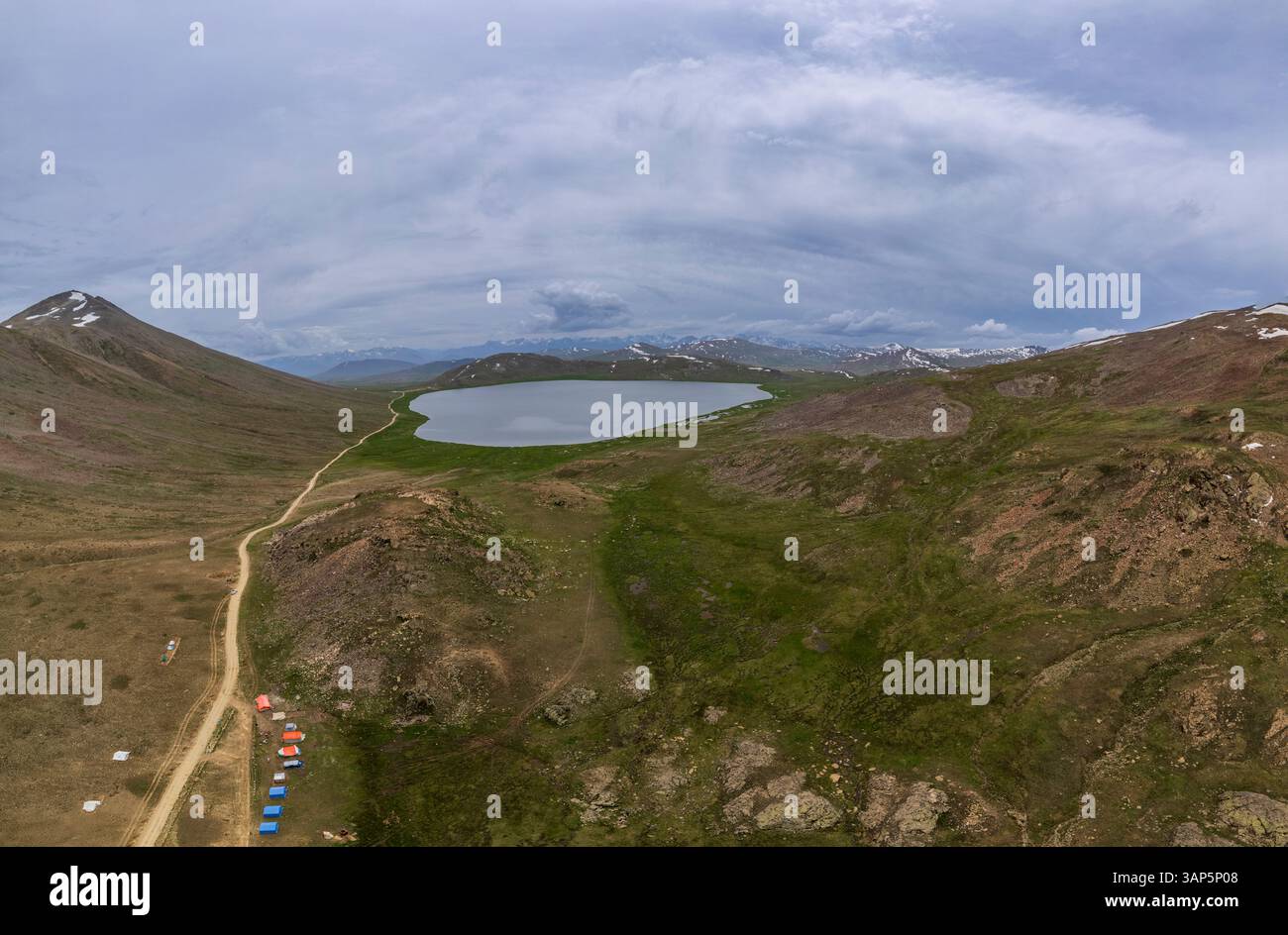 Aerial view of serene Deosai Plains with majestic mountains and a ...