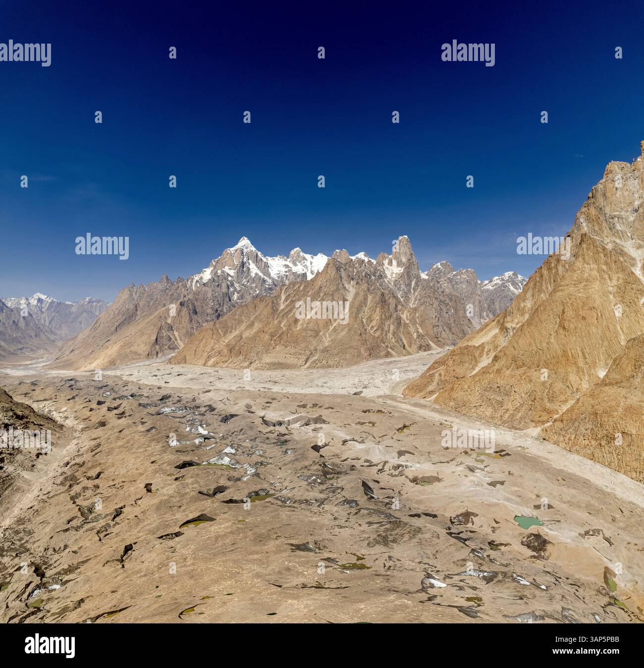 Aerial view of snow-capped mountains and rugged terrain in a remote ...