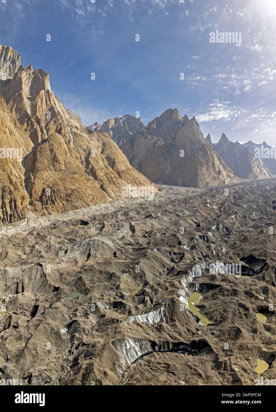Aerial view of majestic snow-capped mountains with rugged terrain and a ...