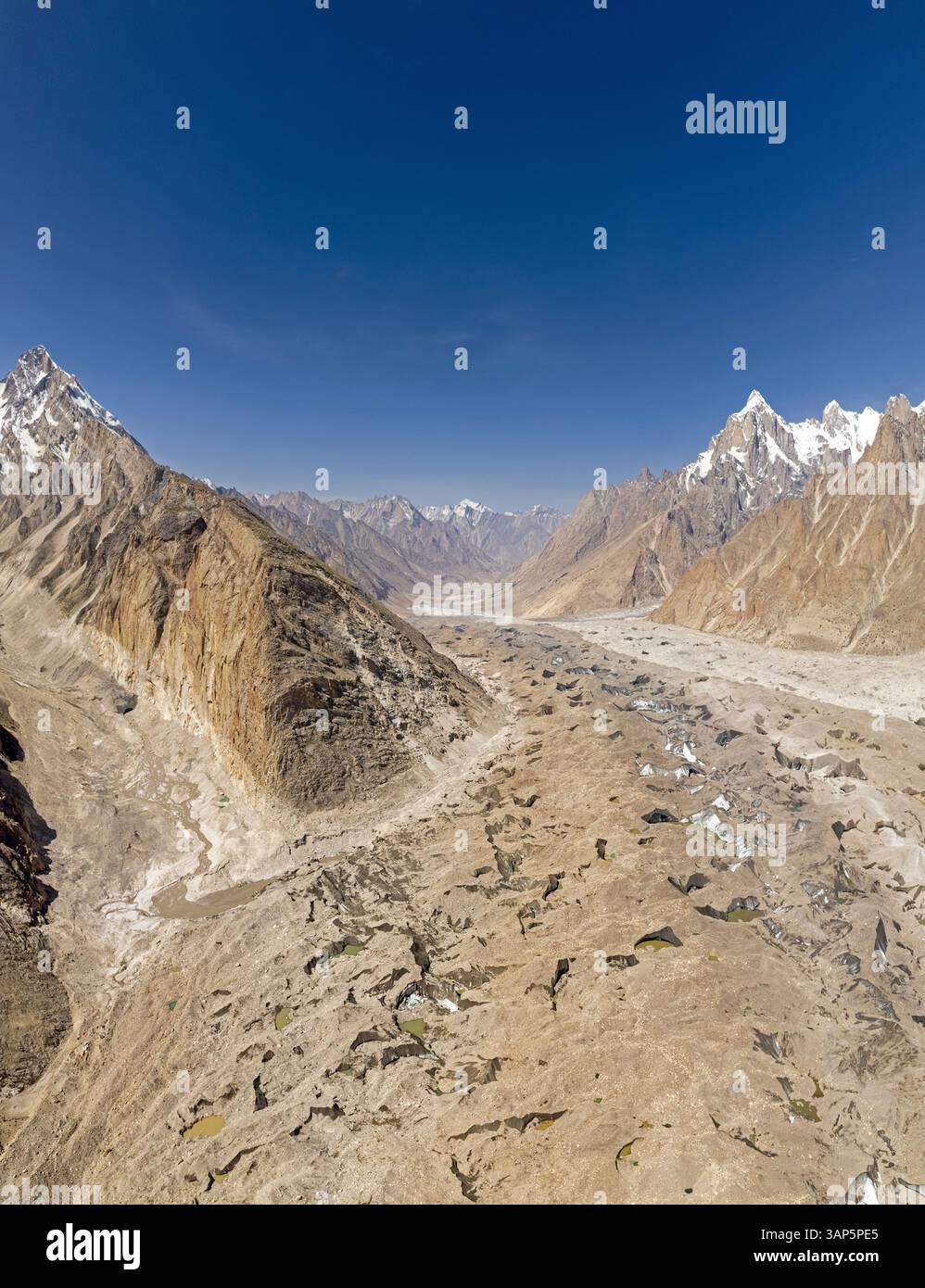 Aerial view of majestic snow-covered mountains and a serene valley ...