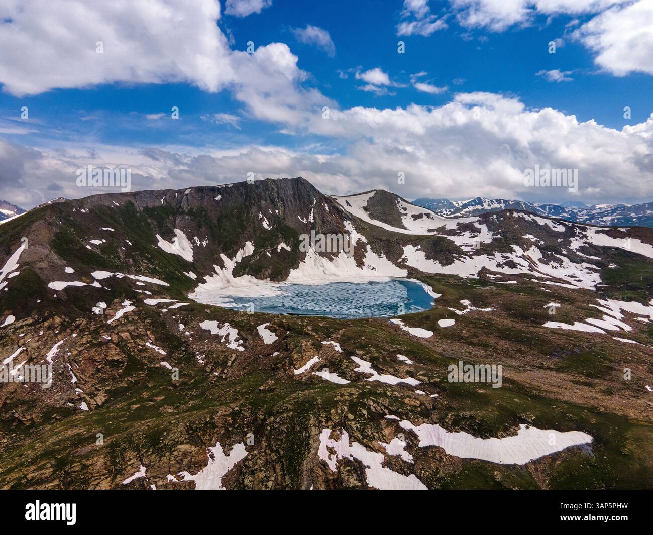 Aerial view of pristine snow-capped mountains and a tranquil lake under ...