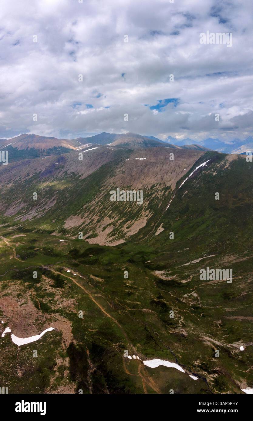 Aerial view of breathtaking mountains and a serene valley under a ...